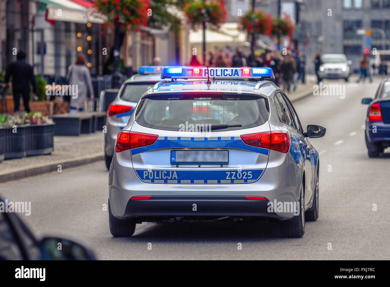 Police cars on patrol with flashing red and blue neon warning lights ...