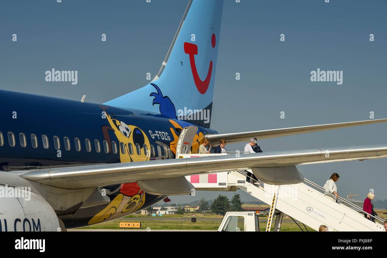 Passengers leaving a TUI holiday jet via the rear steps after arriving ...