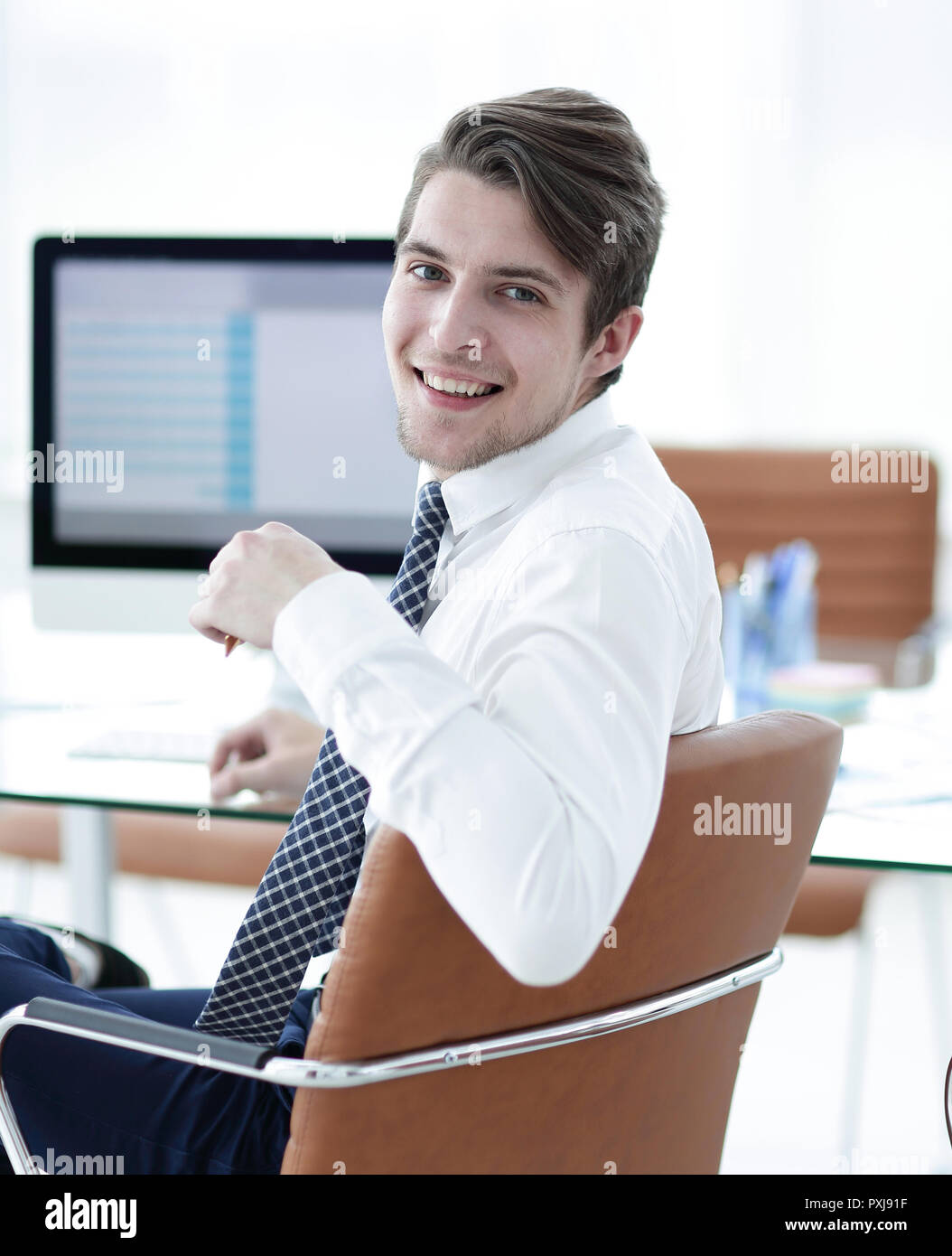closeup. young employee looking at camera .photo with copy space Stock ...
