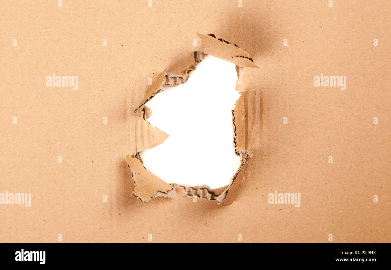 Cardboard with a hole, white background Stock Photo - Alamy