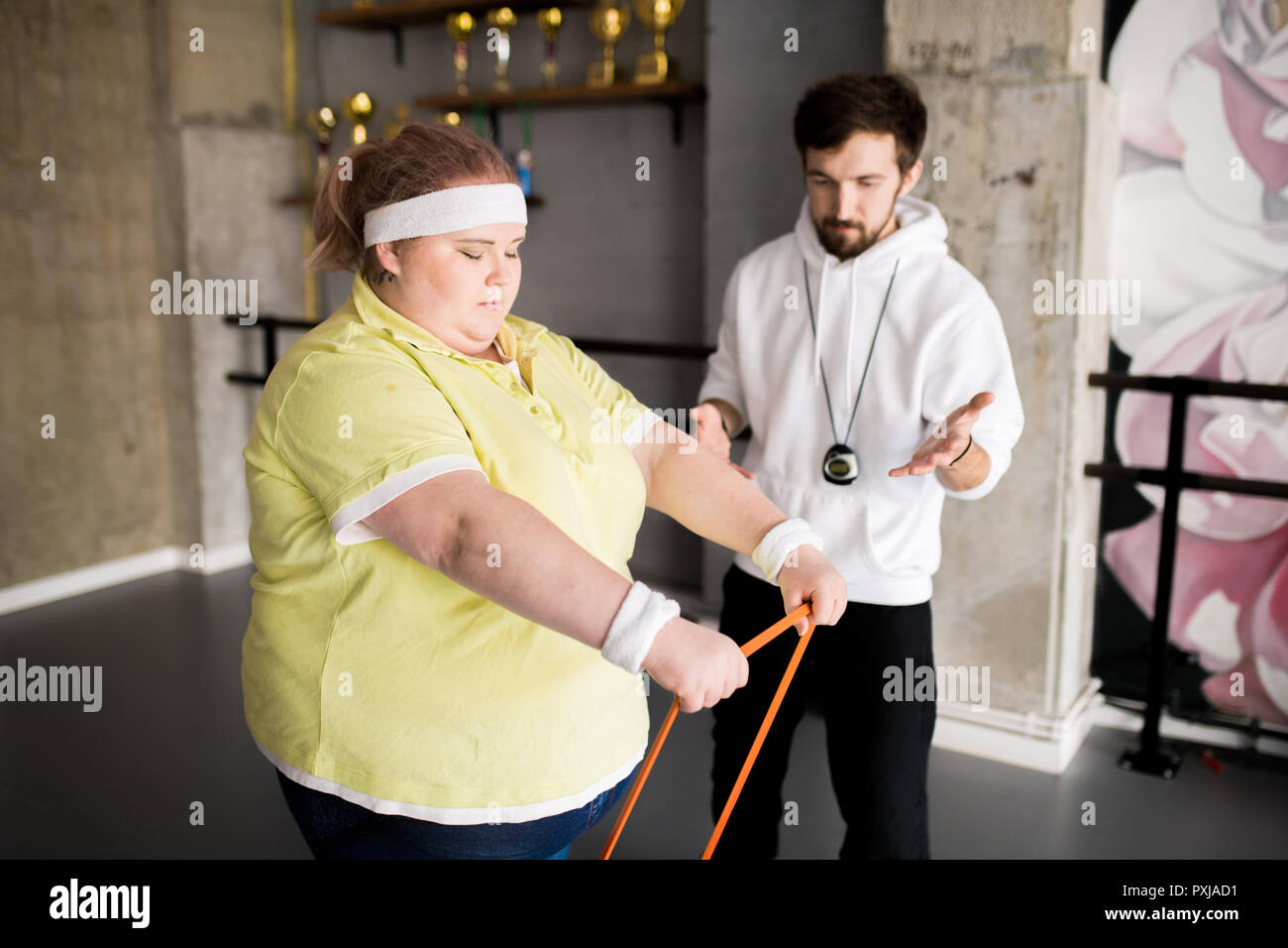 Obese Young Woman Training with Coach Stock Photo - Alamy