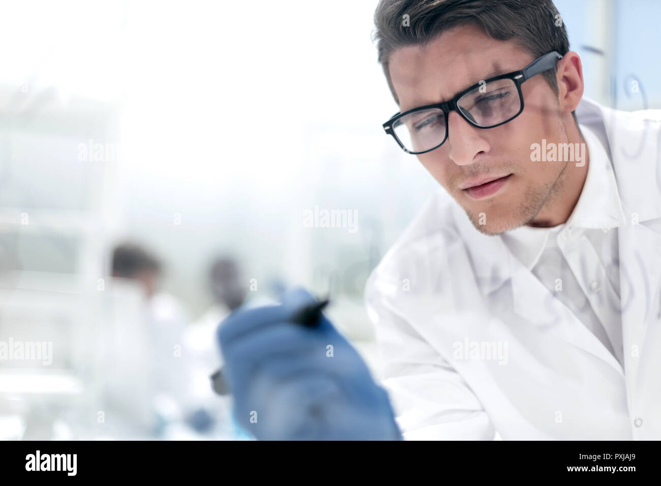 Scientists look at board hi-res stock photography and images - Alamy