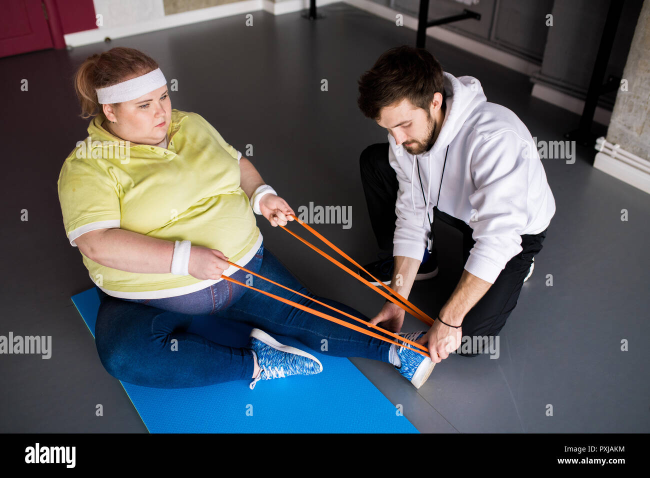Fat Woman Stretching in Fitness Class Stock Photo - Alamy