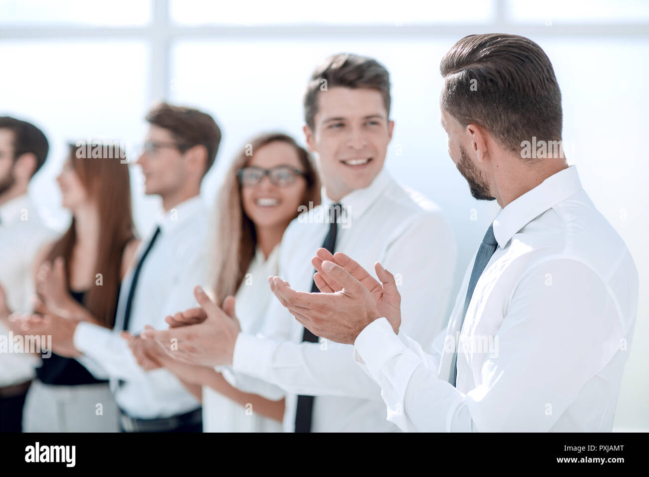 close up.staff a standing ovation in the office Stock Photo - Alamy