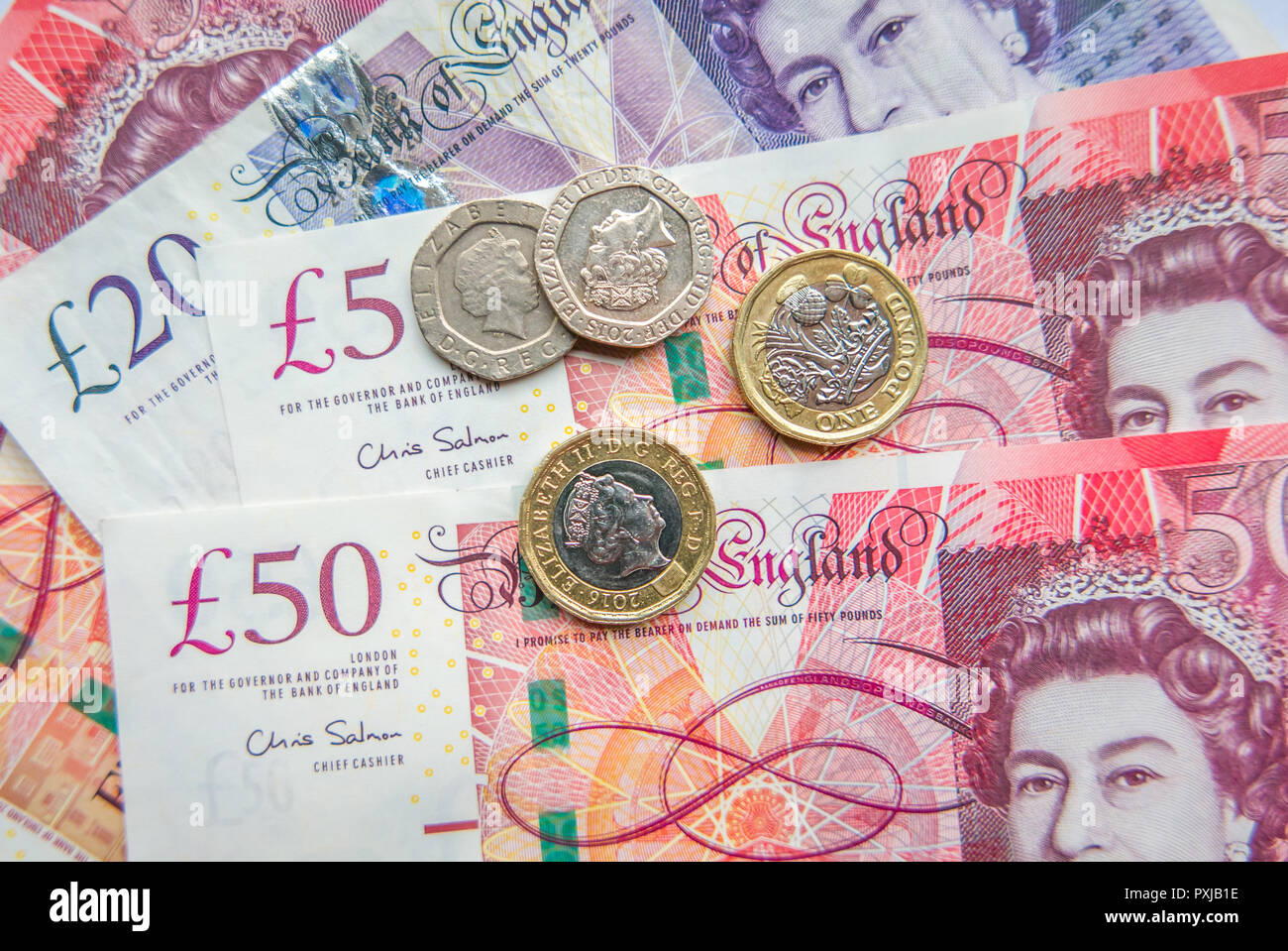 British pound notes and coins financial background Stock Photo - Alamy