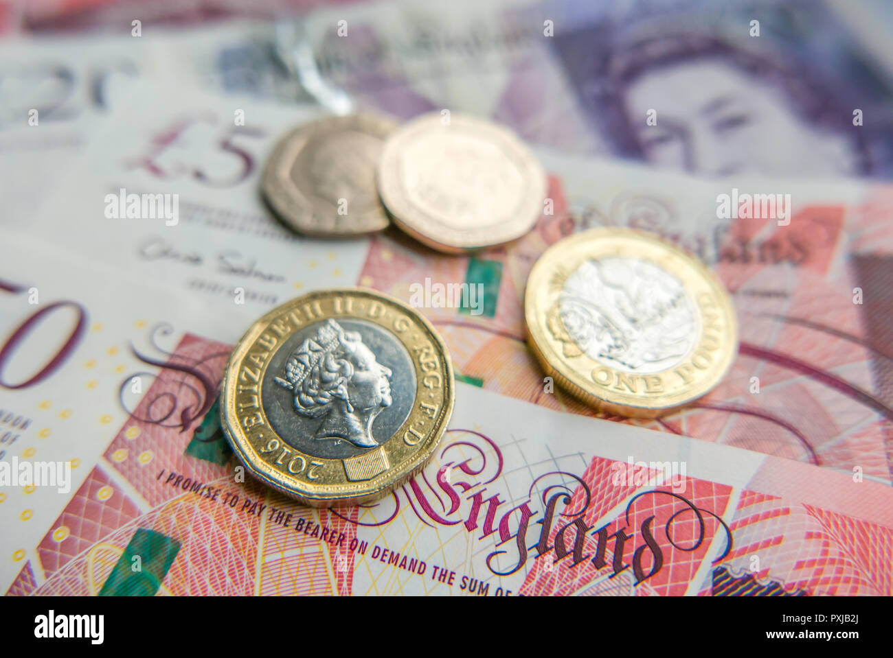 Twenty pound and fifty pound notes with one pound coins hi-res stock ...