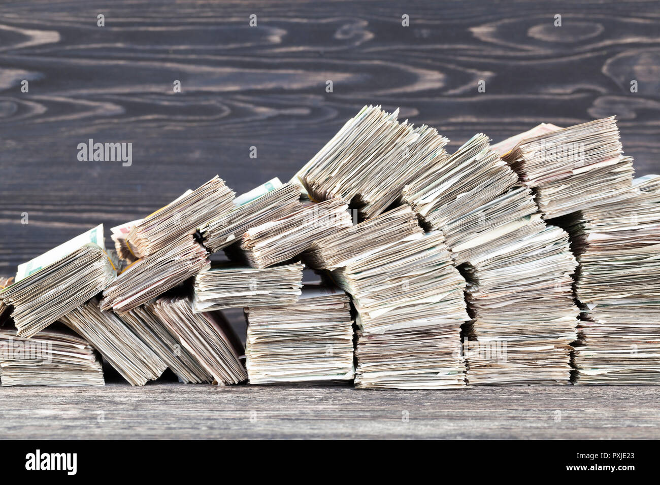 a large number of bundles of paper bills stacked on the table Stock ...