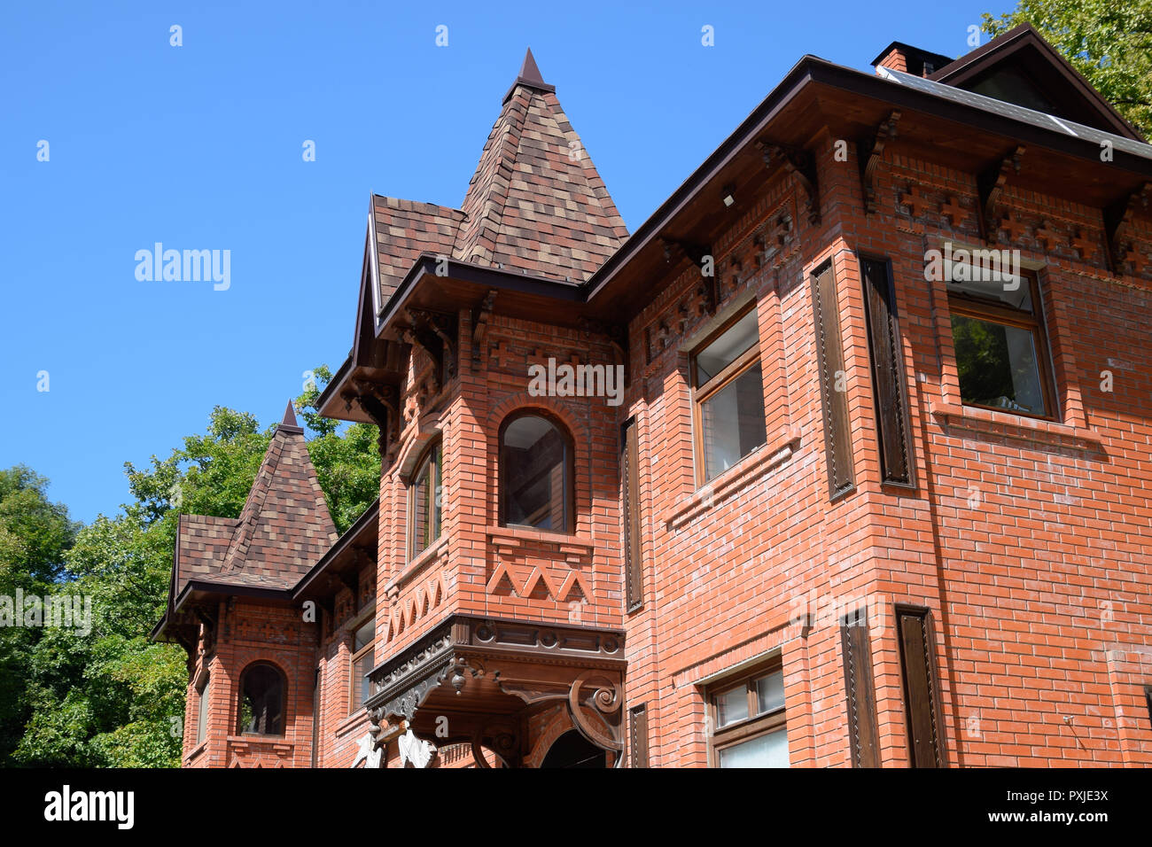 Part of the brick building of red brick and shingles on the roof Stock ...