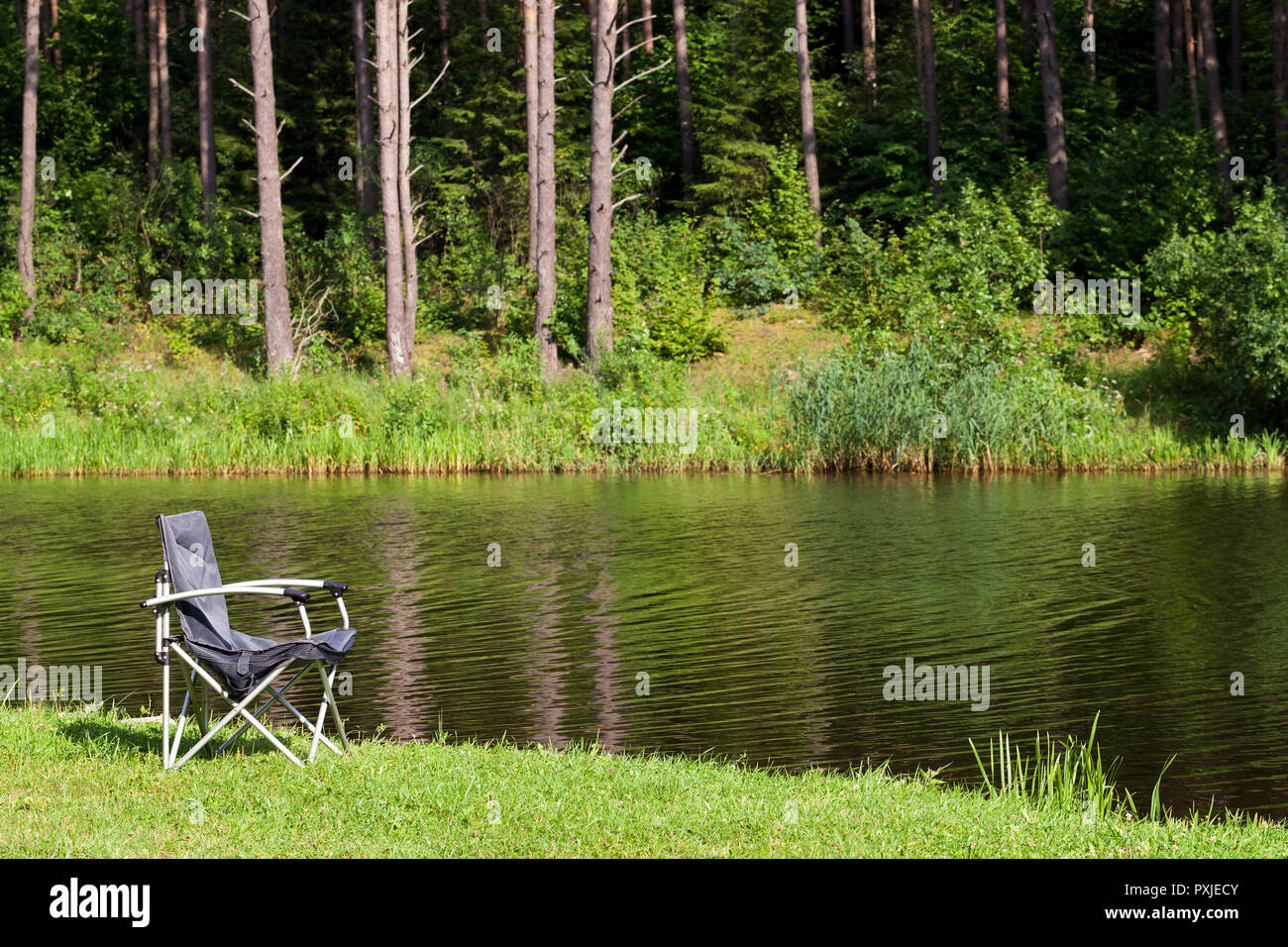 installed on the river bank in the forest folding metal chair for ...
