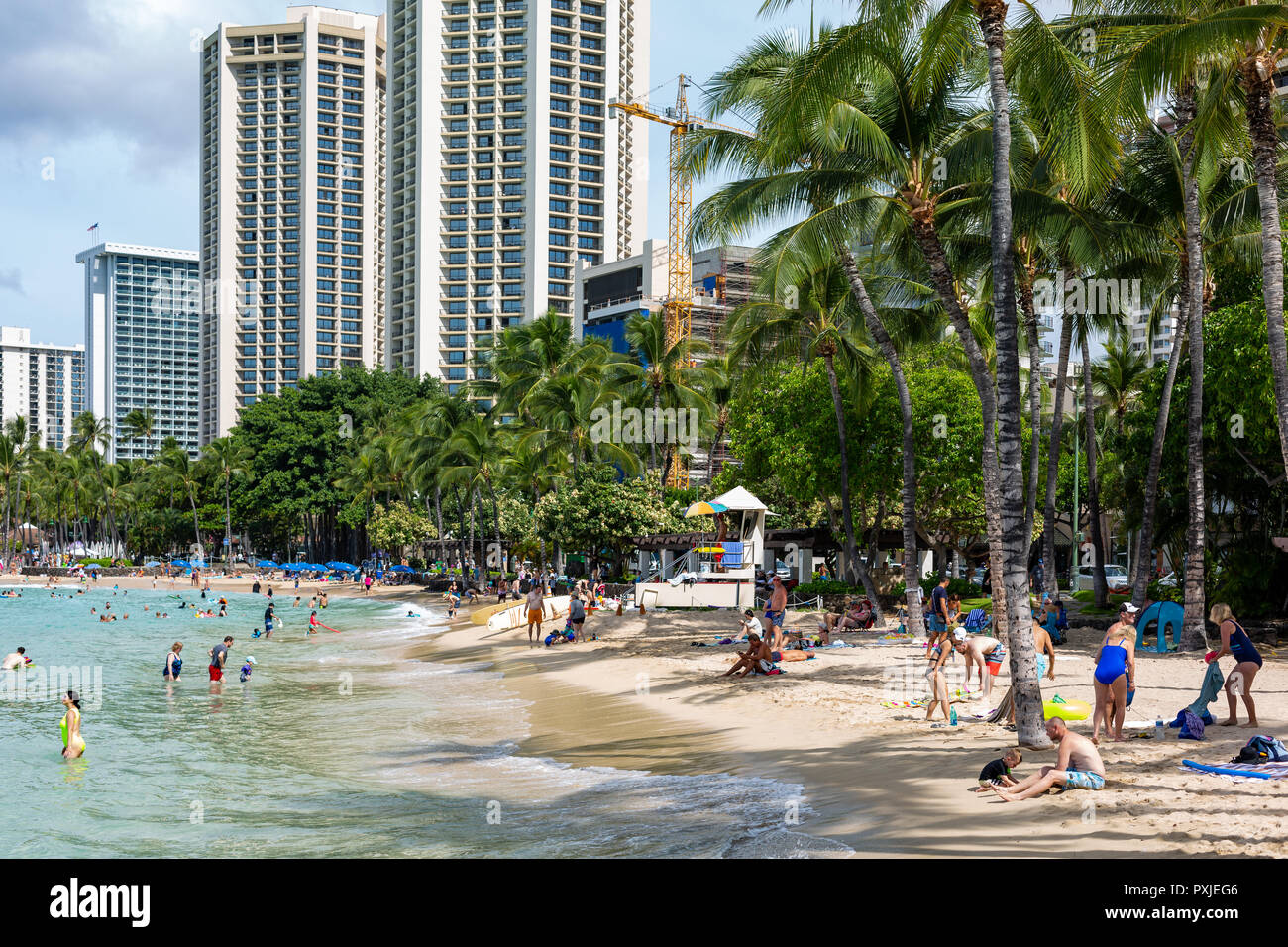 The iconic Waikiki Beach during the day with a crowd of people ...