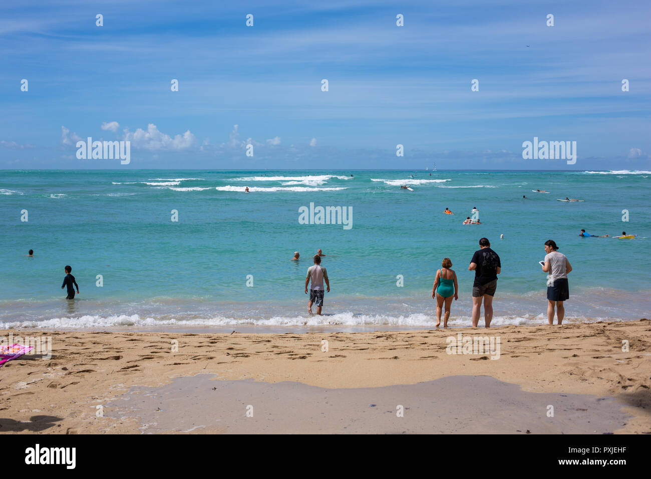 The iconic Waikiki Beach during the day with a crowd of people ...