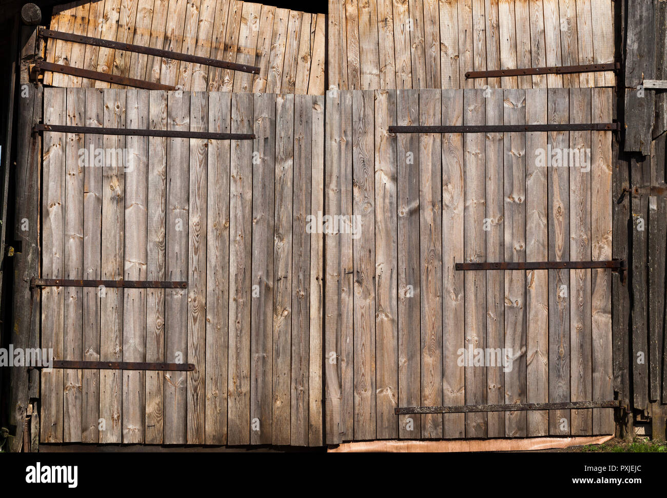 several old wooden gate in a barn in the countryside, close-up of an ...
