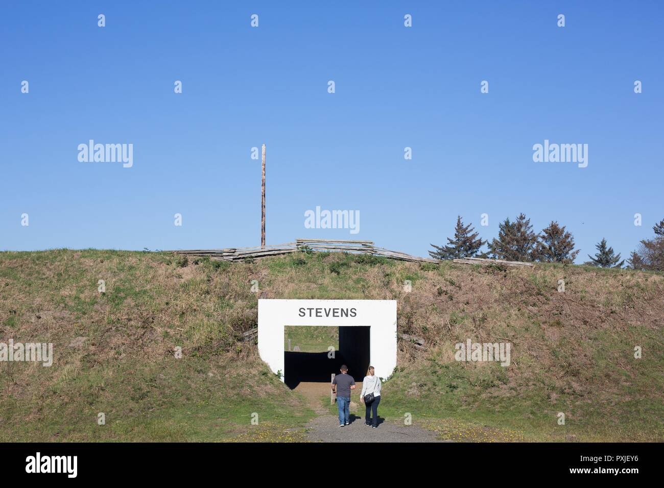Tourists walking into a tunnel at Fort Stevens in Hammond, Oregon, USA ...