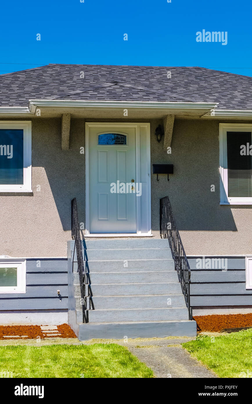 Entrance of modest residential house. Family house with freshly mowed ...