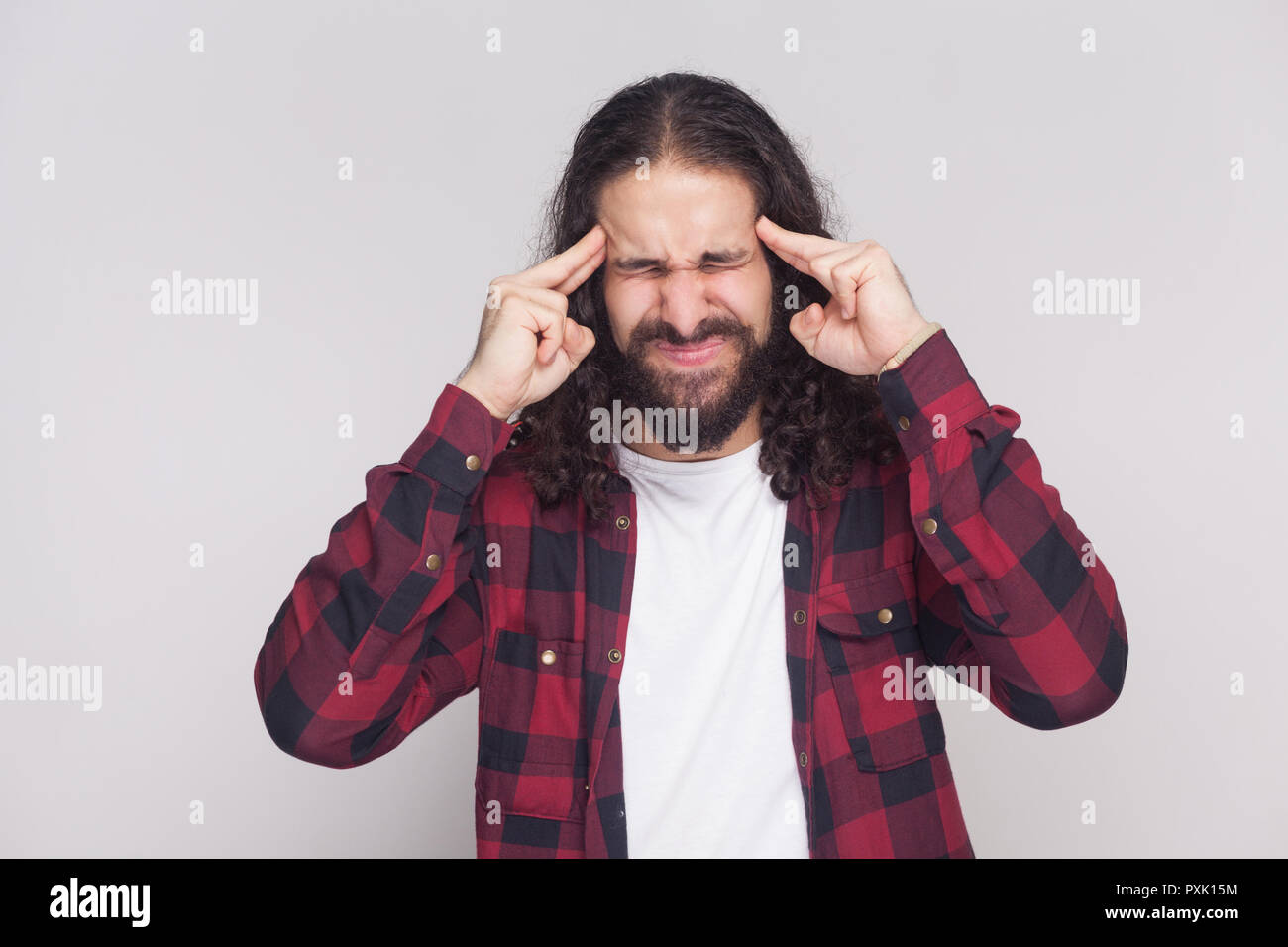 confused handsome man with beard and black long curly hair in casual ...