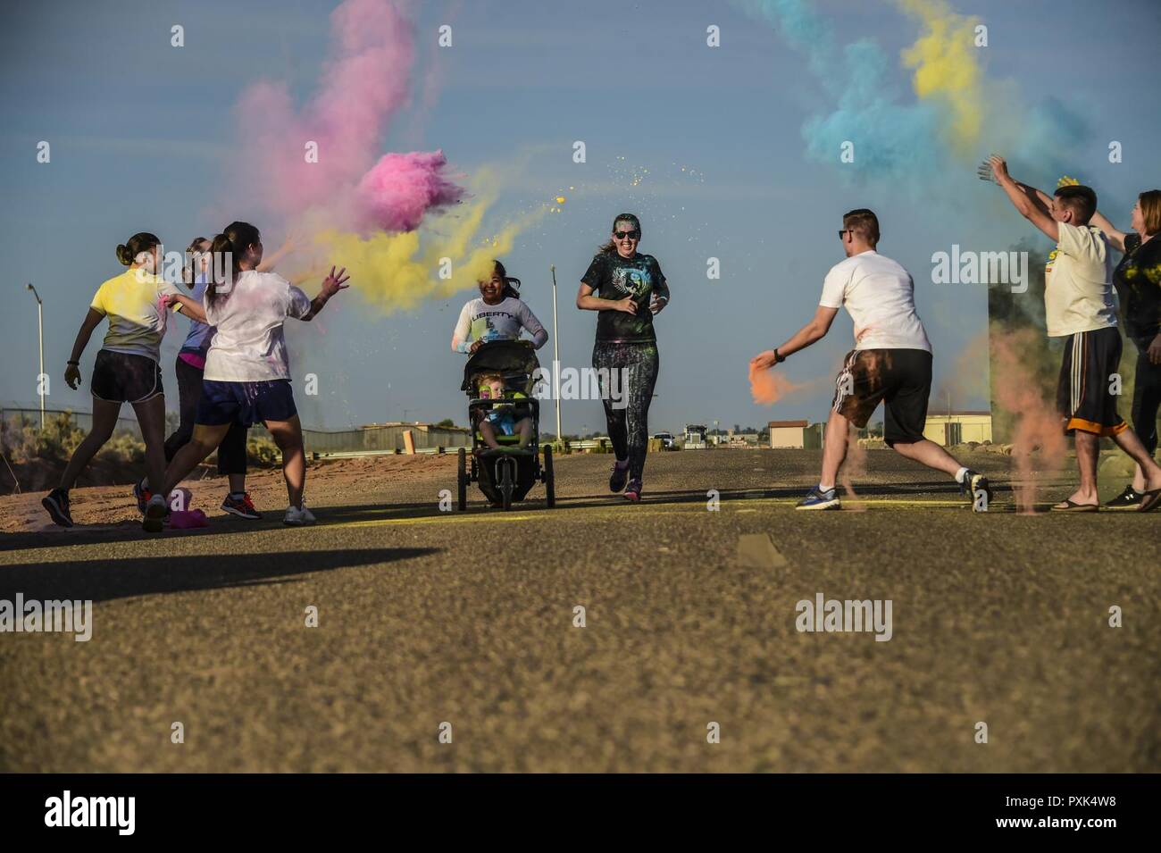 Runners participating in the LGBT Pride Month 5k color run pass through ...