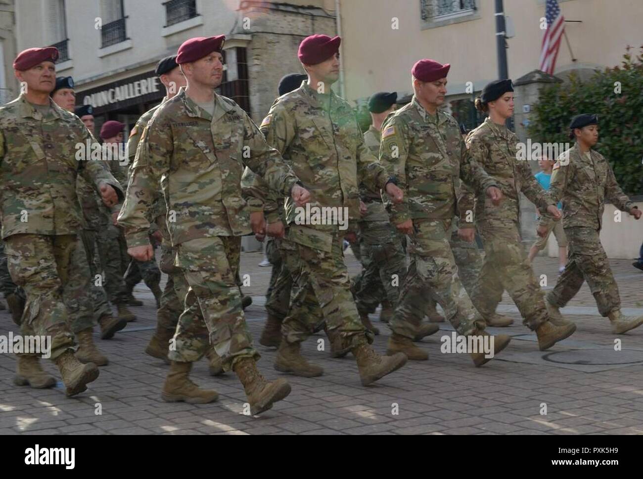 U.S. Army Soldiers march through Carentan from the Carre de Choux ...