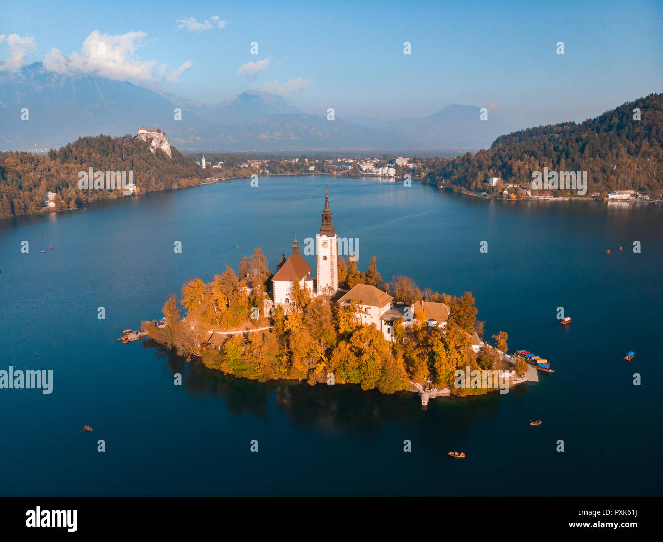 Aerial view of Bled island on lake Bled, and Bled castle and mountains ...