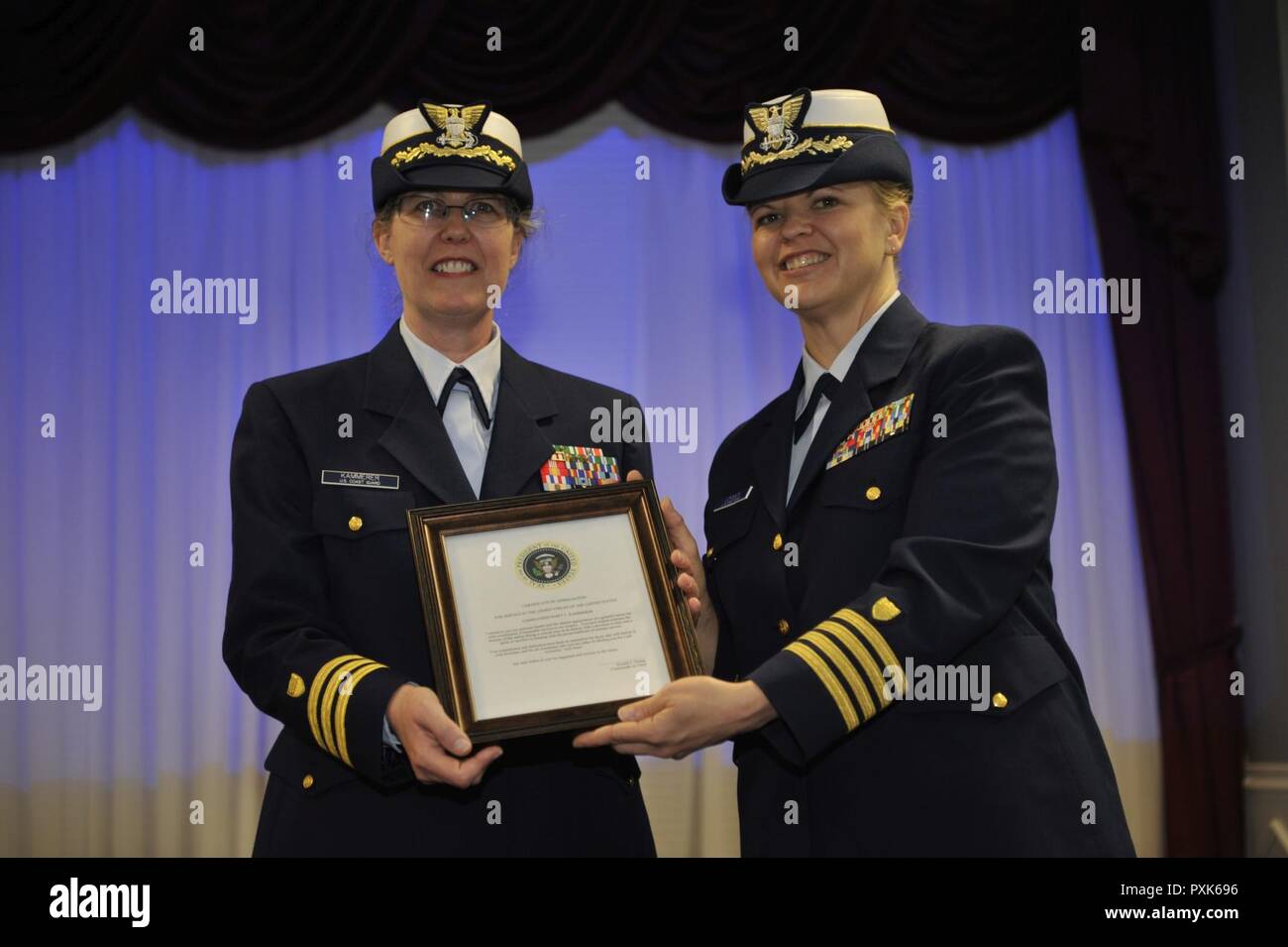 Coast Guard Capt. Richelle Johnson, right, presents reservist Cmdr ...