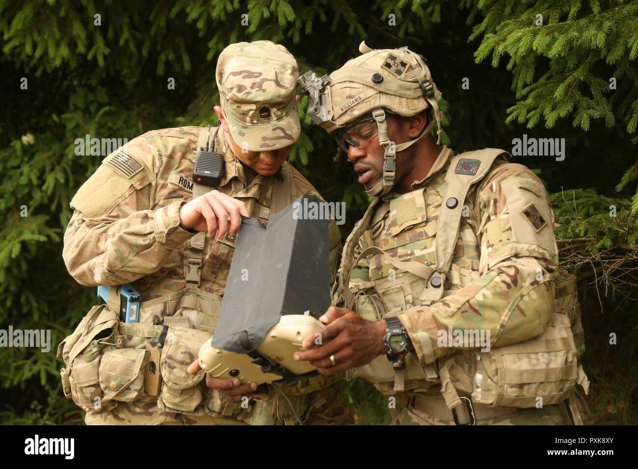 U.S. Army Sgt. 1st Class Joseph Rombold, left, of Joint Multinational ...