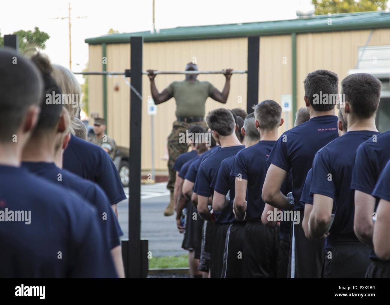 A U.S. Marine demonstrates how to conduct pull-ups for future Marines ...