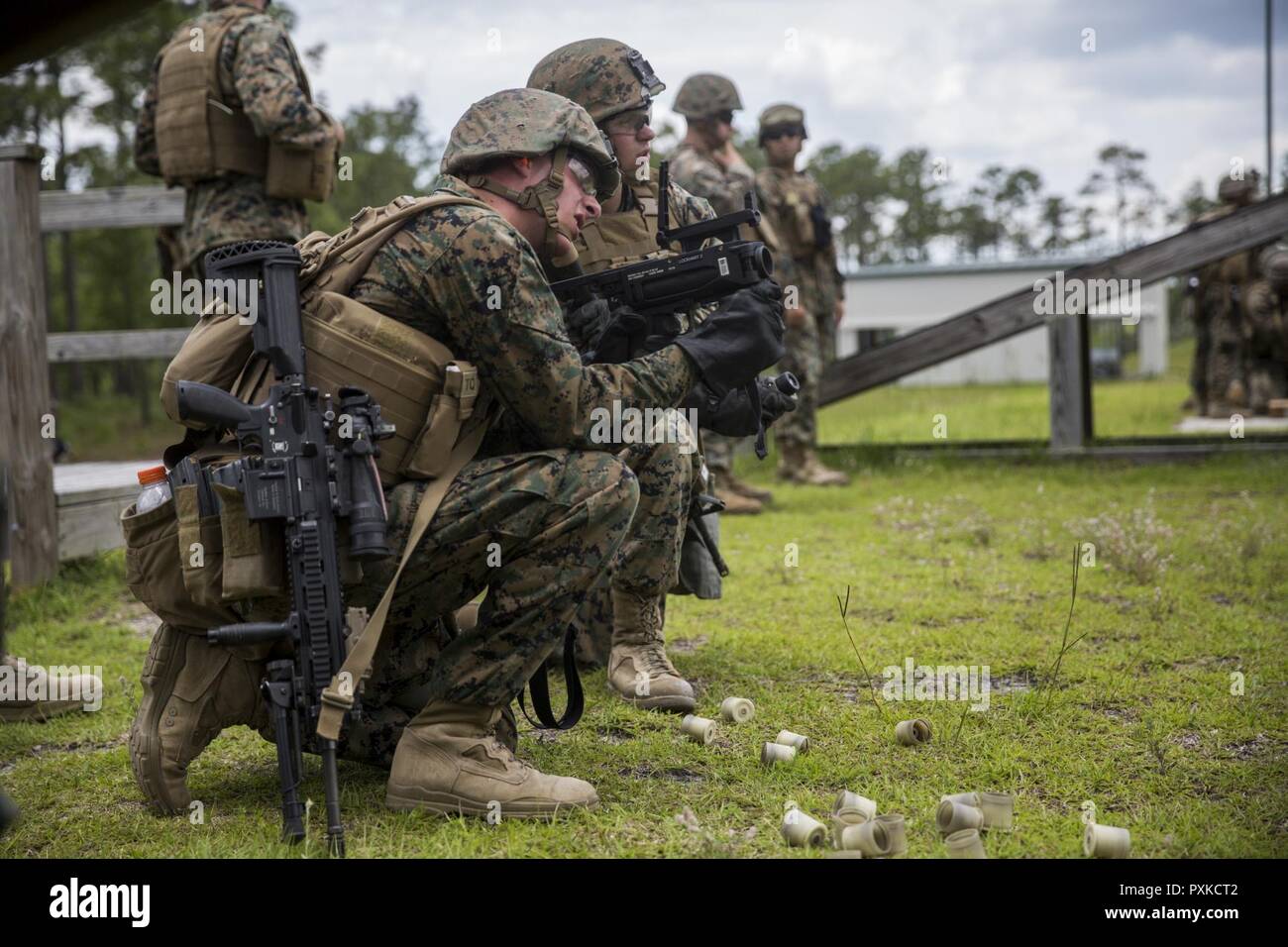 A Marine sights in on a target with an M320 grenade launcher module at ...