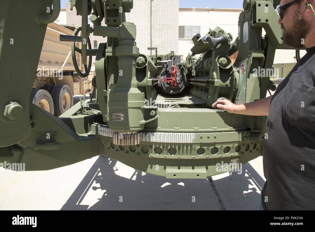 David Vierheller, artillery repair specialist, points out the breech on ...