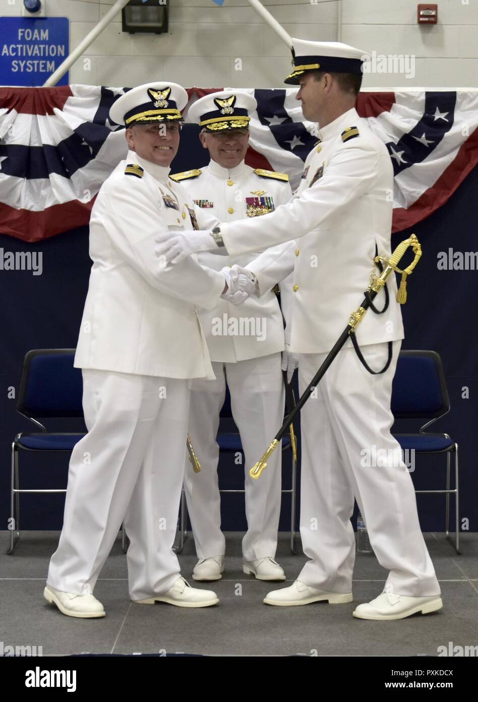 Capt. Arthur Snyder, outgoing commander, shakes hands with Capt ...