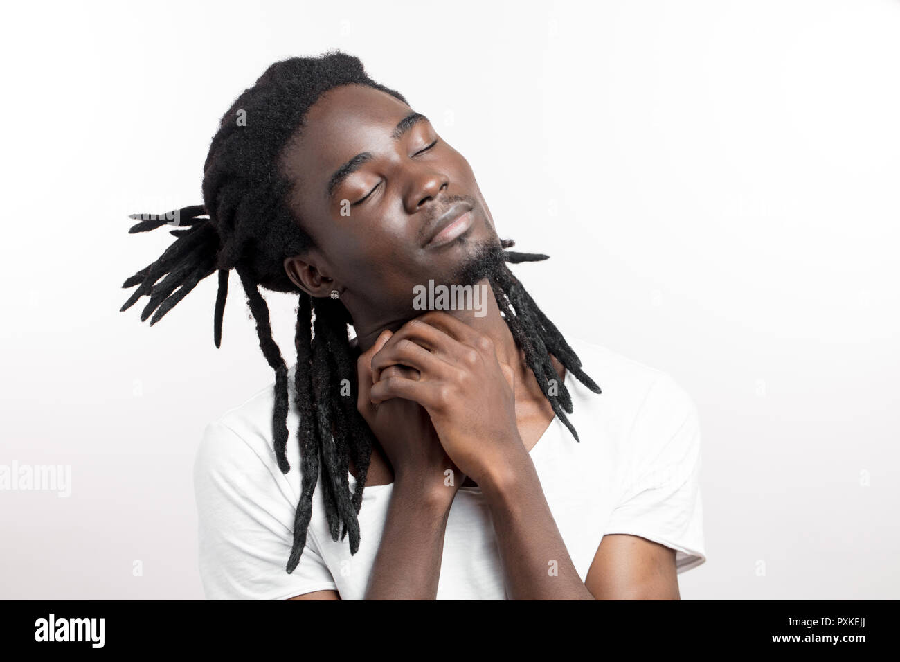 Thinking or dreaming african man with dreadlocks on white background ...