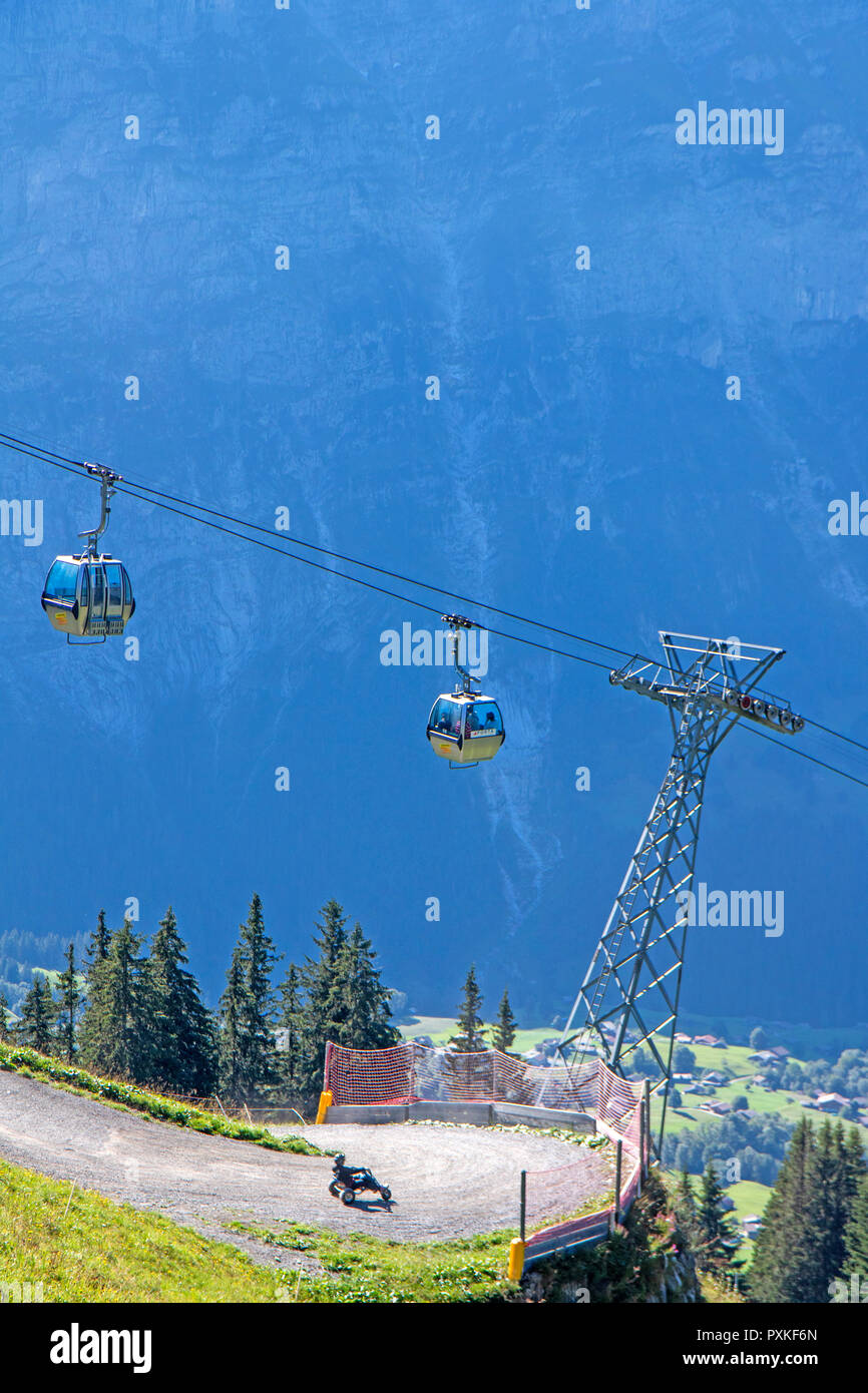 Mountain carts below the First cable car above Grindelwald Stock Photo ...