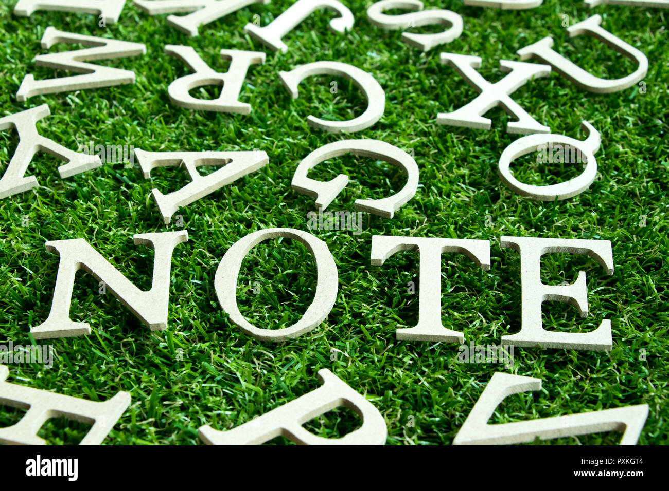 Wood alphabet in wording note on artificial green grass background ...