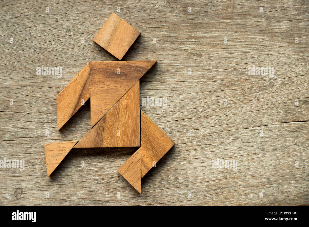 Wood tangram puzzle as man running background (Concept as business ...