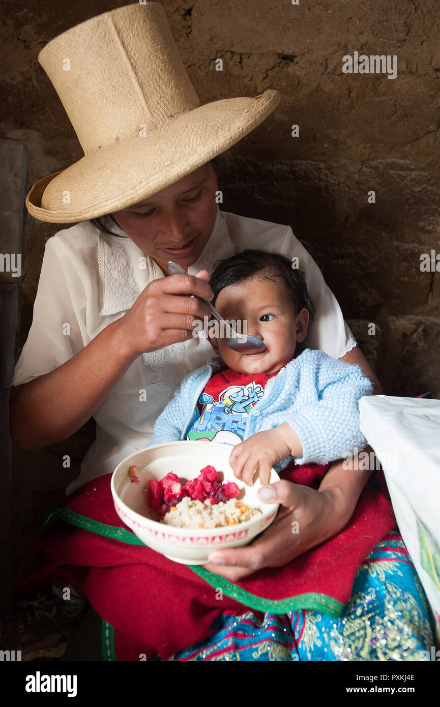 Mothet feeding her son. Peruvian Andean area. Pamparomas. Ancash. Peru ...