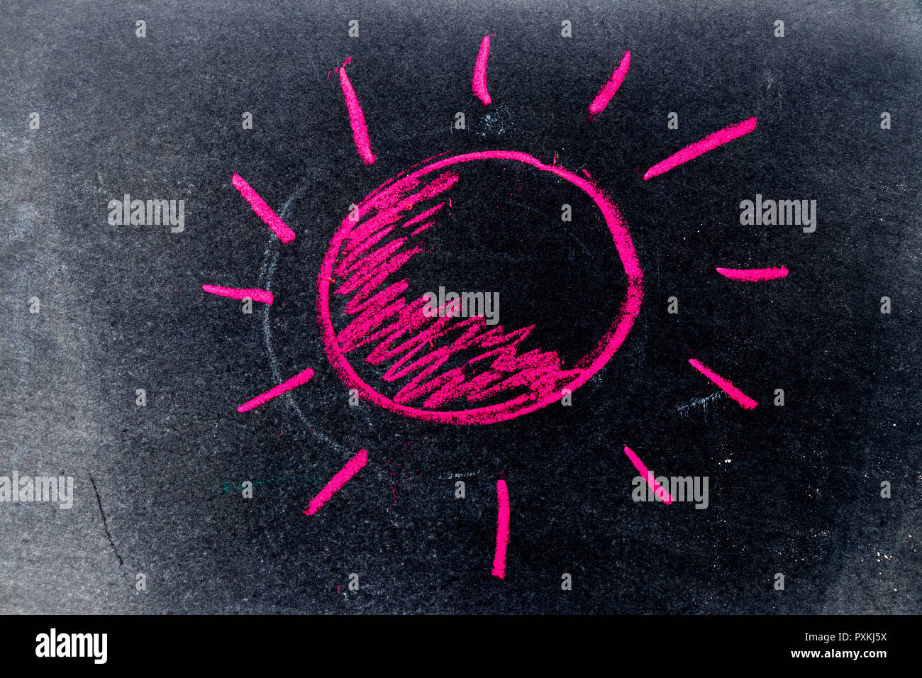 Red chalk drawing as sun with ray on black board background Stock Photo ...
