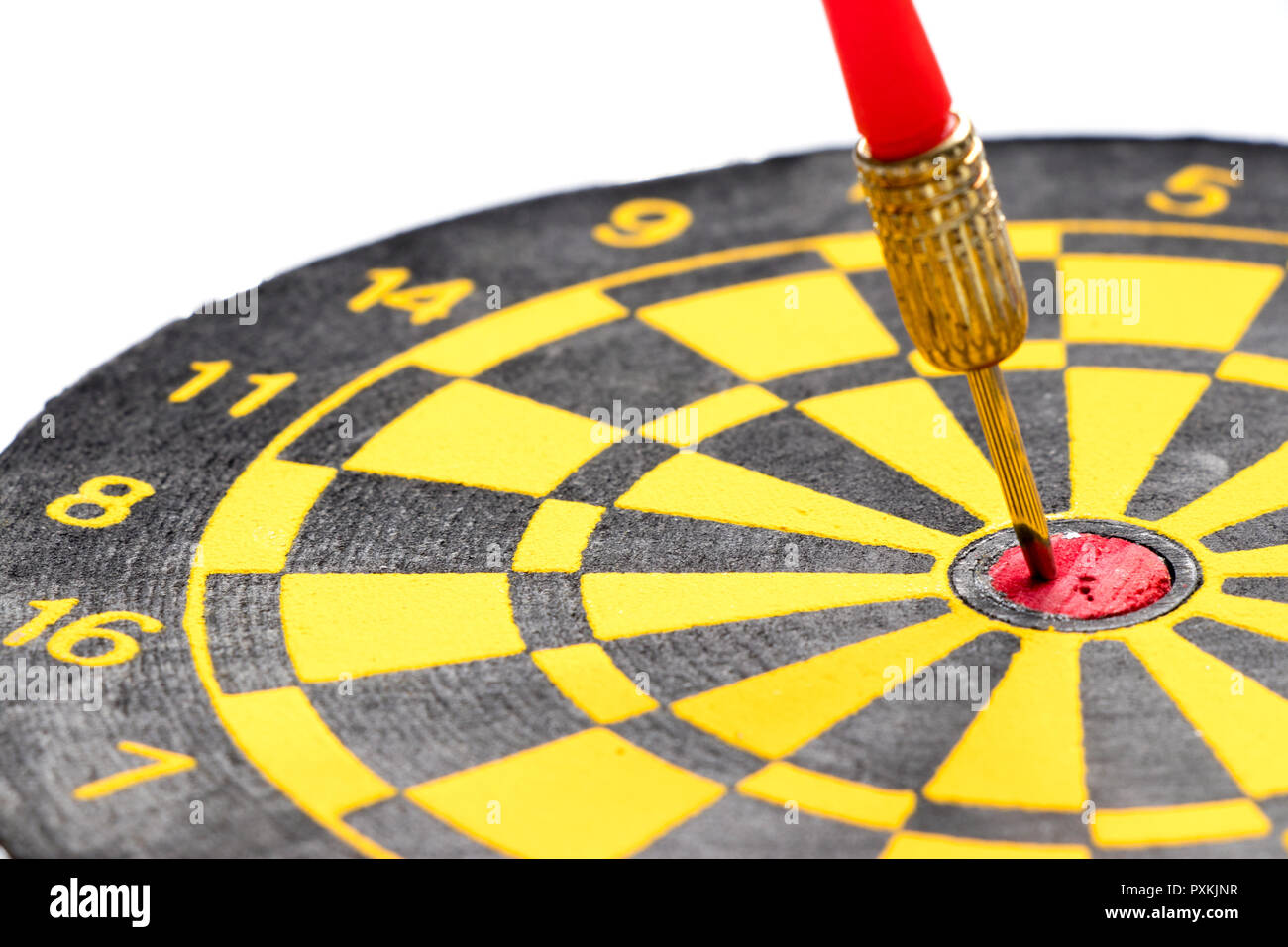 Yellow and black color dartboard with number and have the dart hit at ...