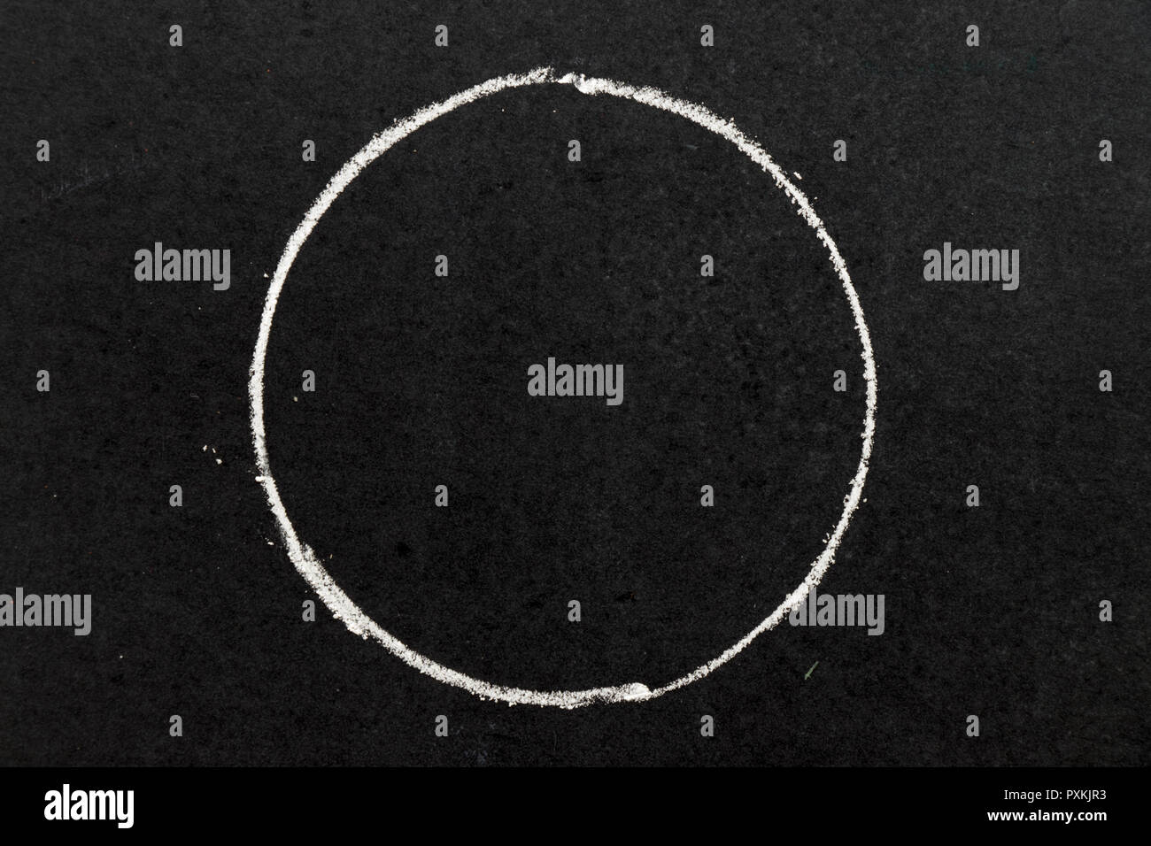 White chalk hand drawing as circle shape on black board background ...