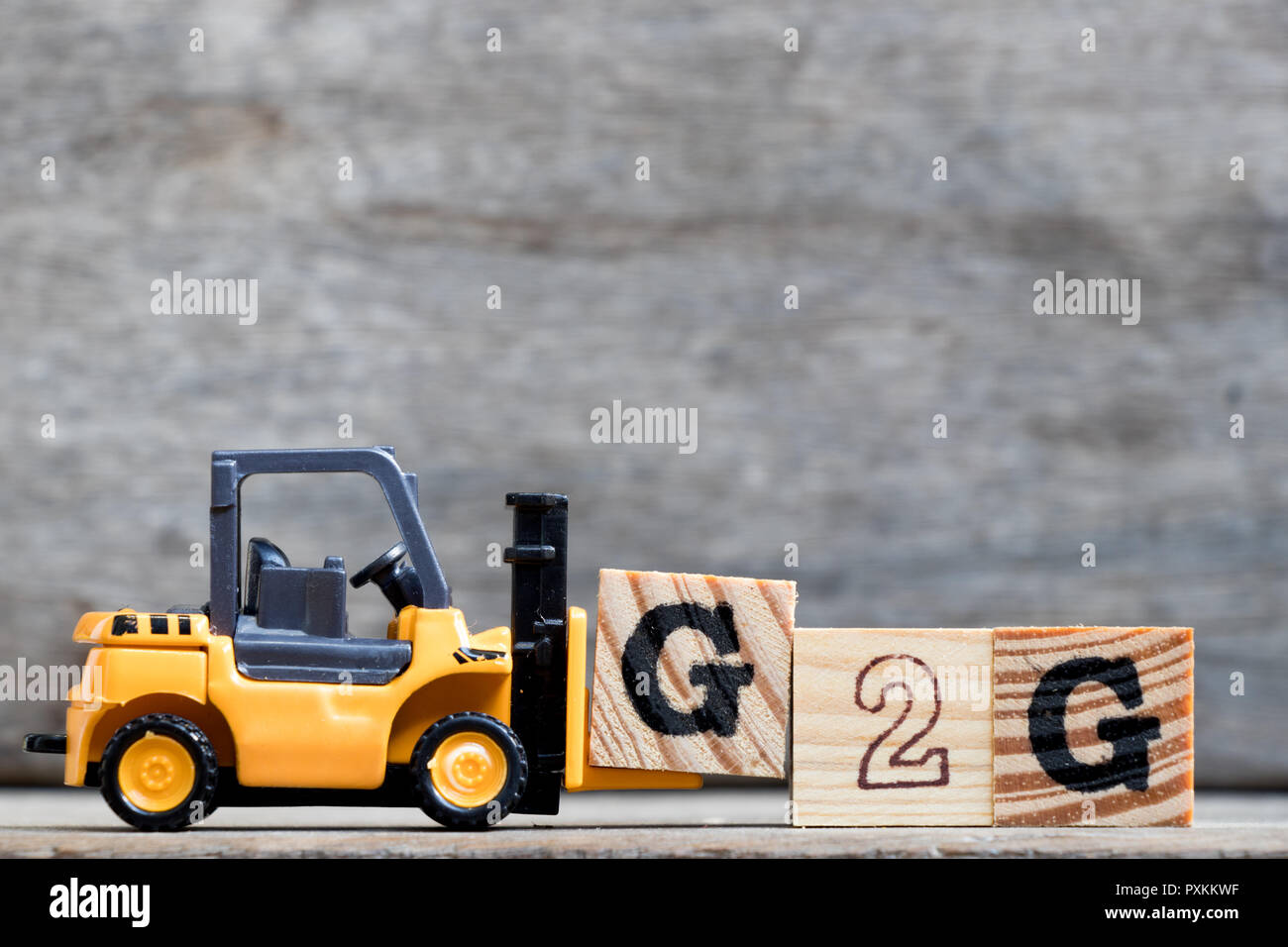 Yellow plastic forklift hold letter G to complete word G2G (Government ...