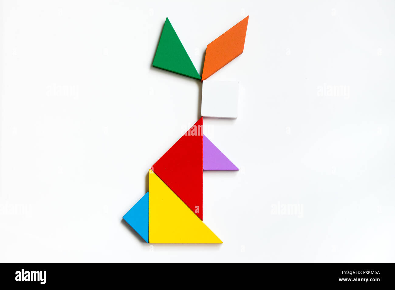 Colorful wood tangram puzzle in sitting rabbit shape on white ...