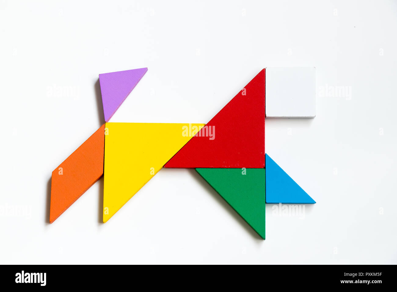 Colorful wood tangram puzzle in running dog shape on white background ...