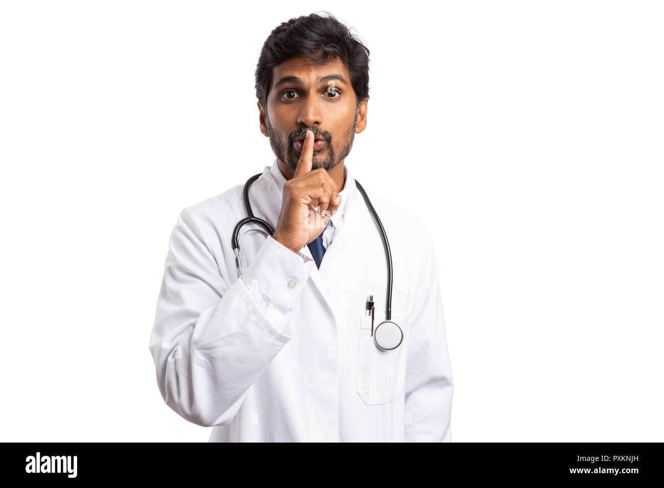 Male indian doctor making keep quiet gesture with index finger touching ...