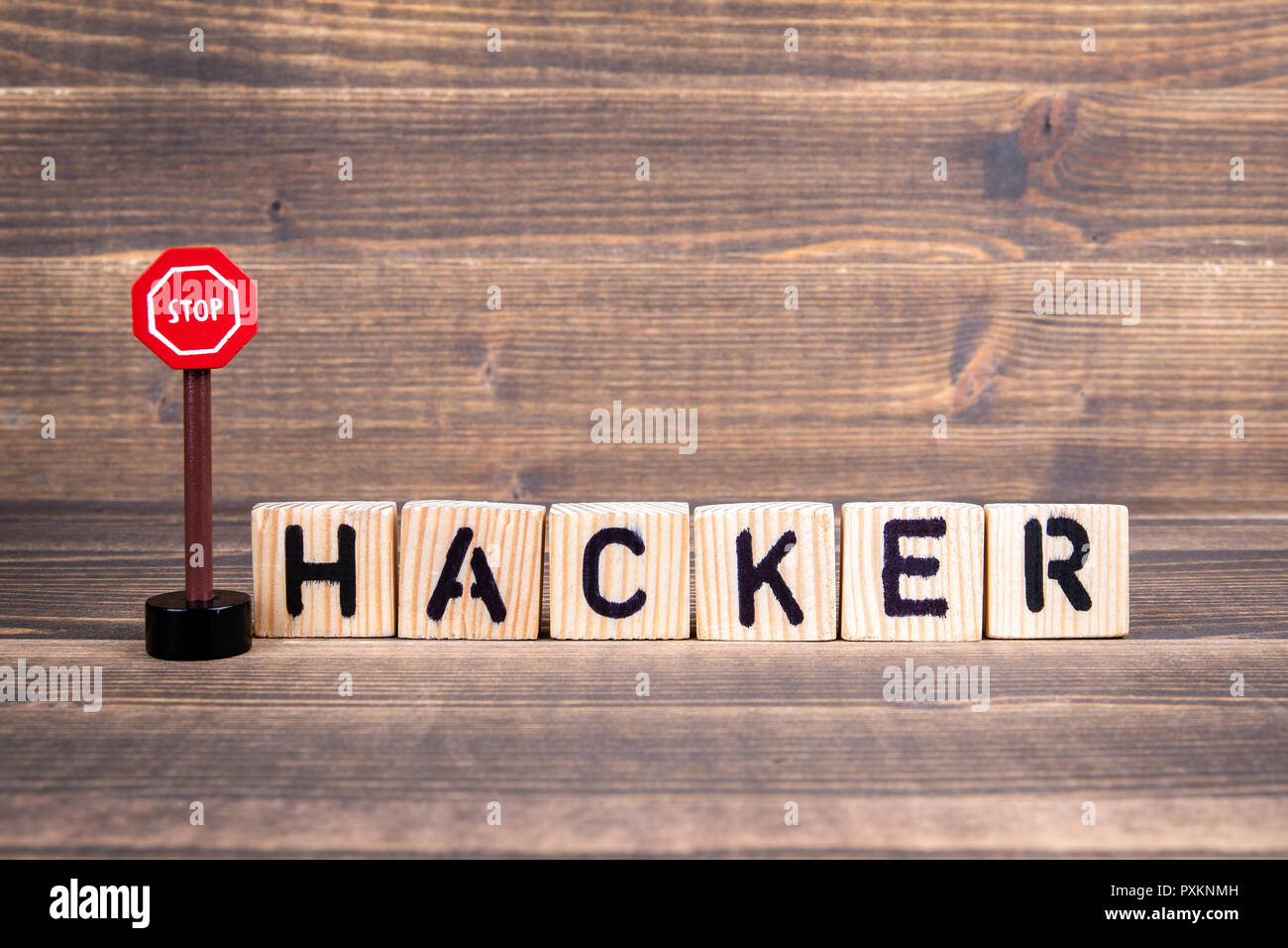 Hacker concept. Wooden letters with road sign on wooden background ...