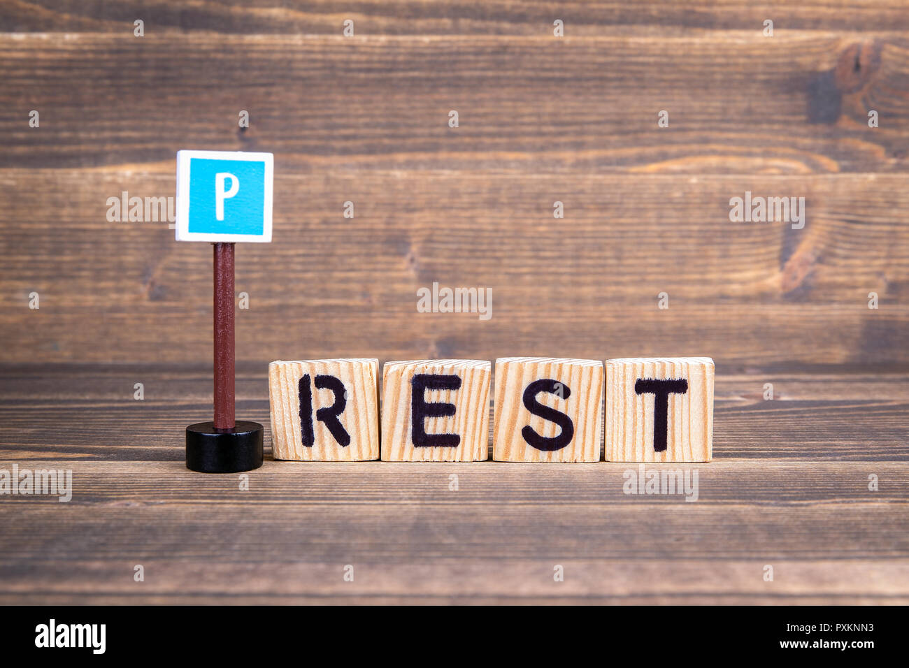 Rest name from wooden letters with road sign on wooden background Stock ...
