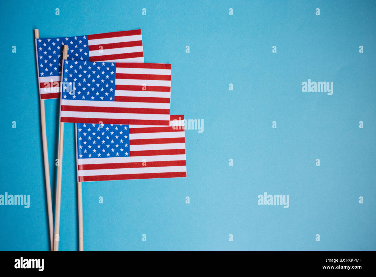 Miniature paper flag USA. American Flag on blue background Stock Photo ...