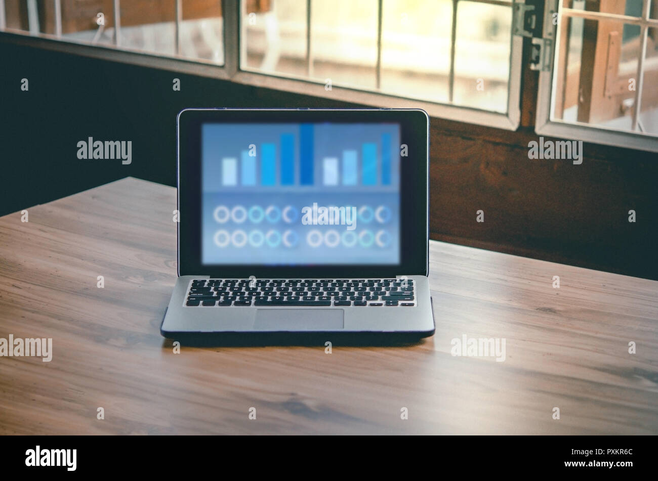 Workplace with notebook laptop Comfortable work table in office windows ...