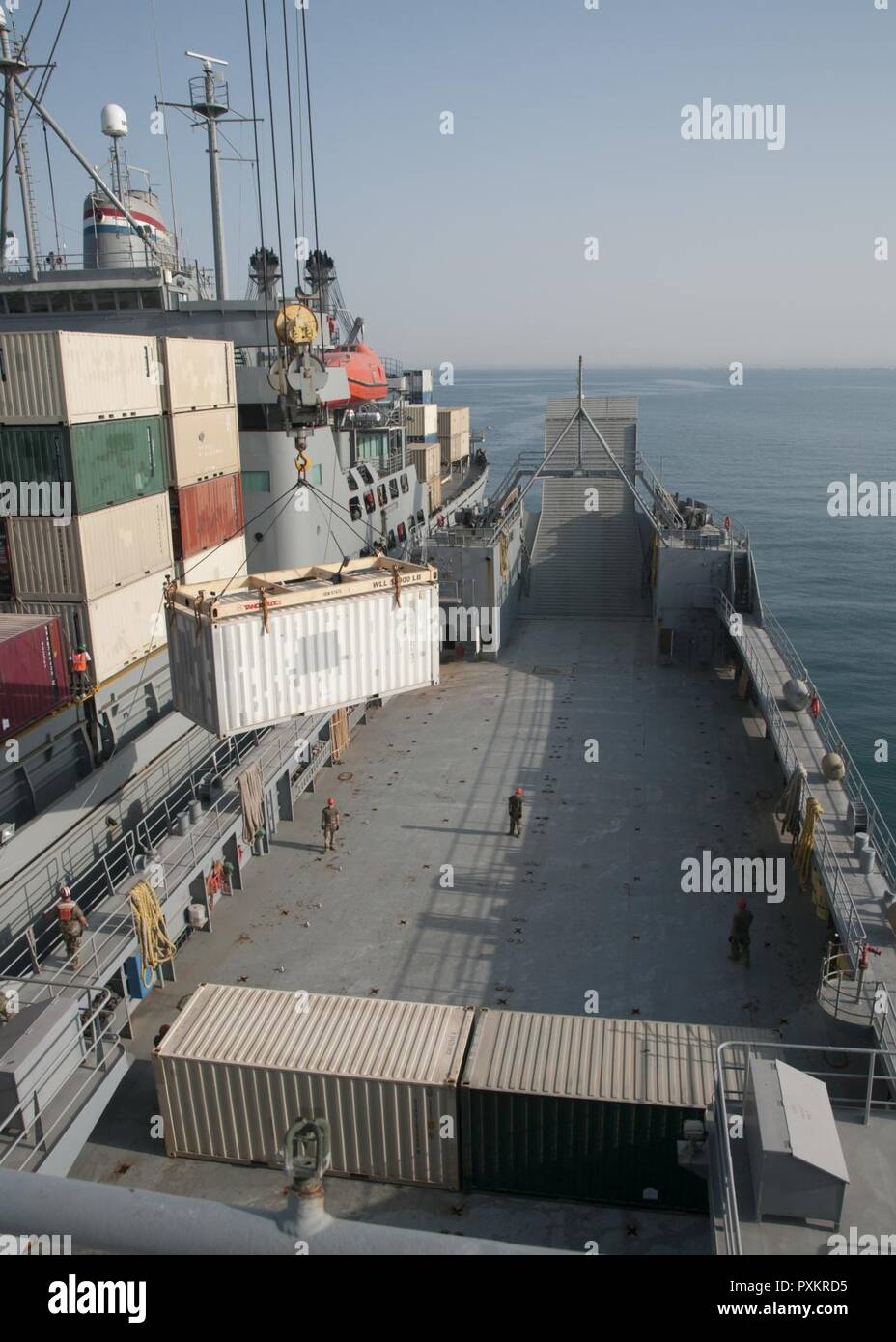 The Military Sealift Command Vessel Gem State transfers a container to ...
