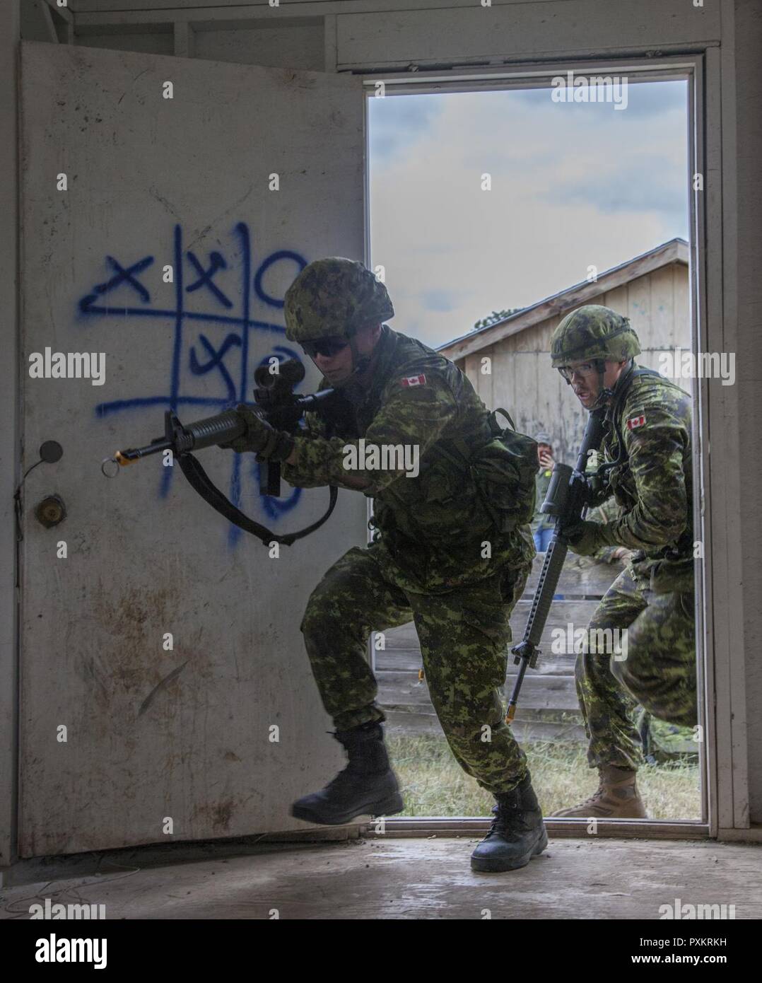 Soldiers of the 3rd Canadian Division, Canadian Army clear a room ...