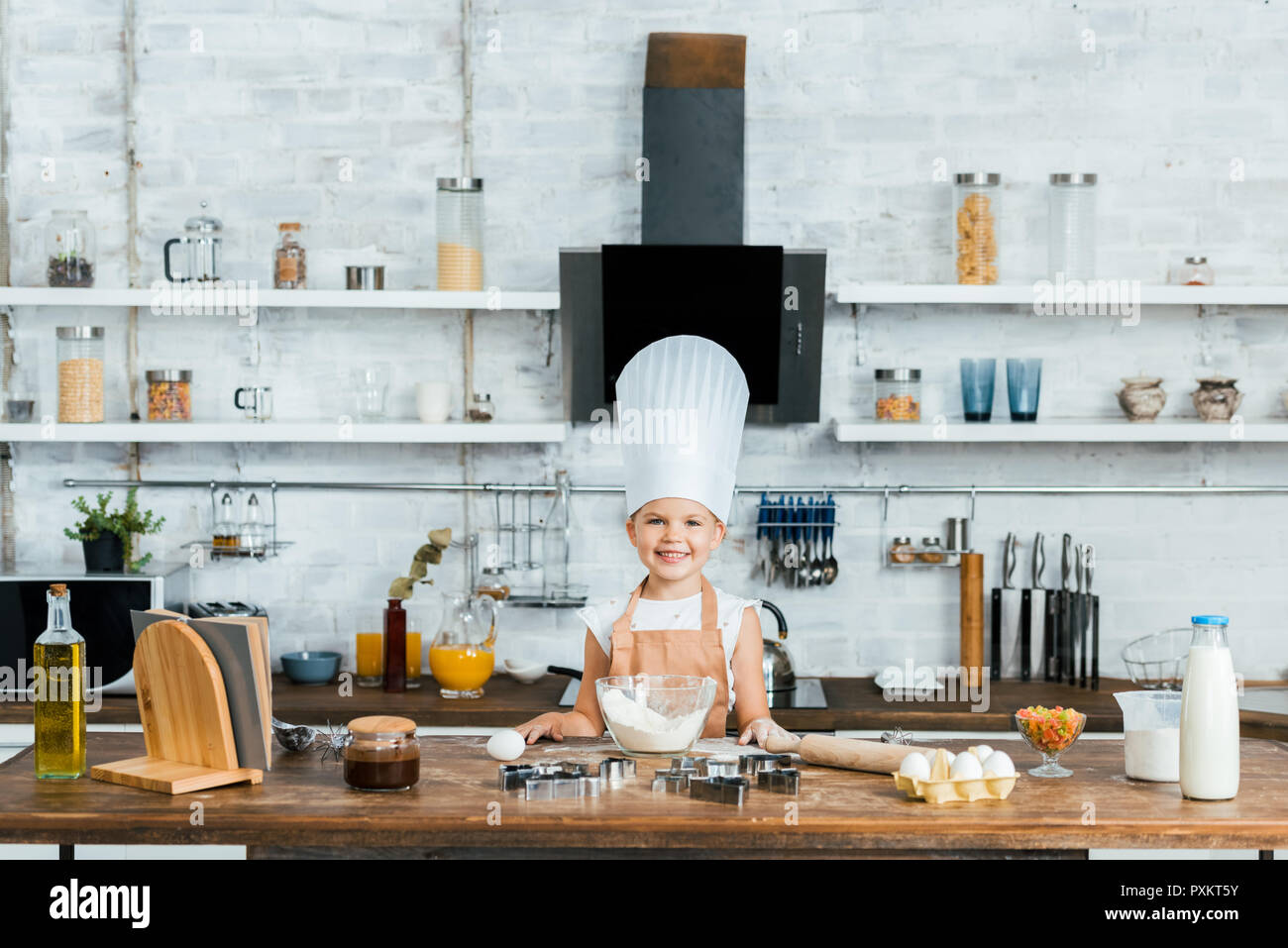 Adorable child girl cook in hi-res stock photography and images - Alamy
