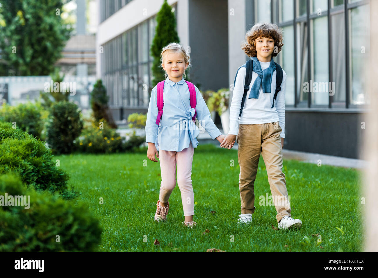 Children friends walking school backpacks hi-res stock photography and ...