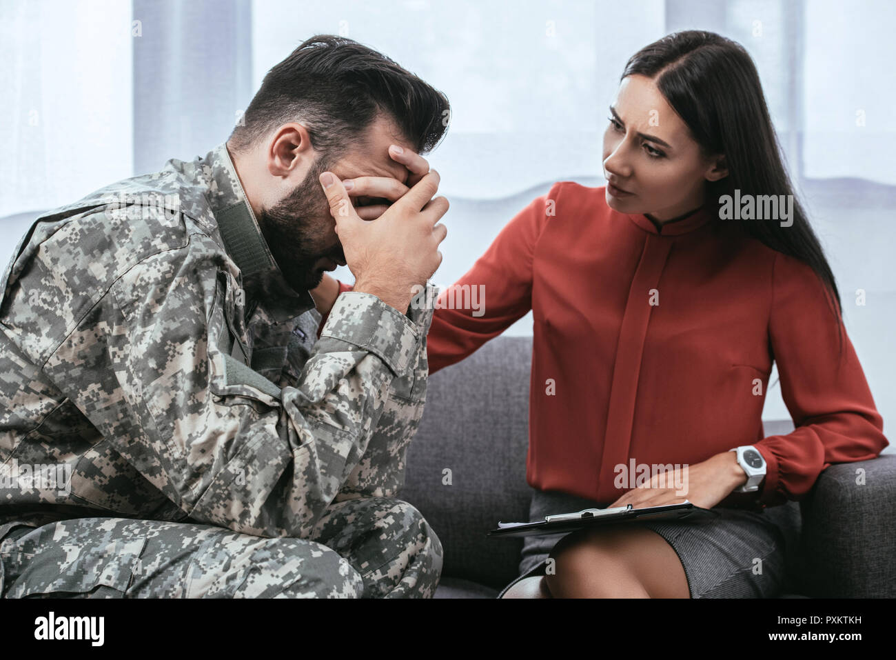 Depressed female soldier sitting hi-res stock photography and images ...