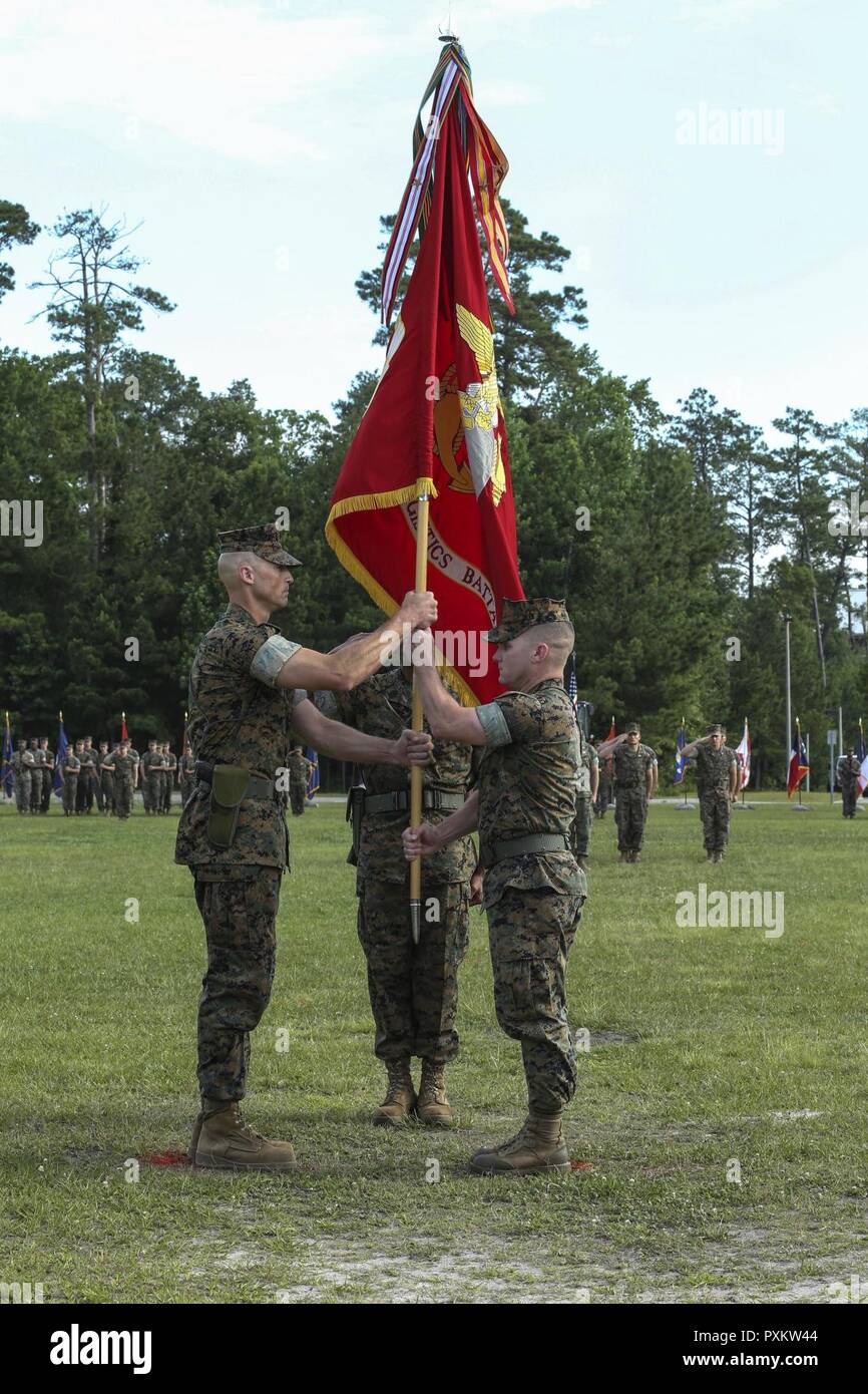 U.S. Marine Corps Lt. Col. Todd B. Sanders, right, passes the Marine ...